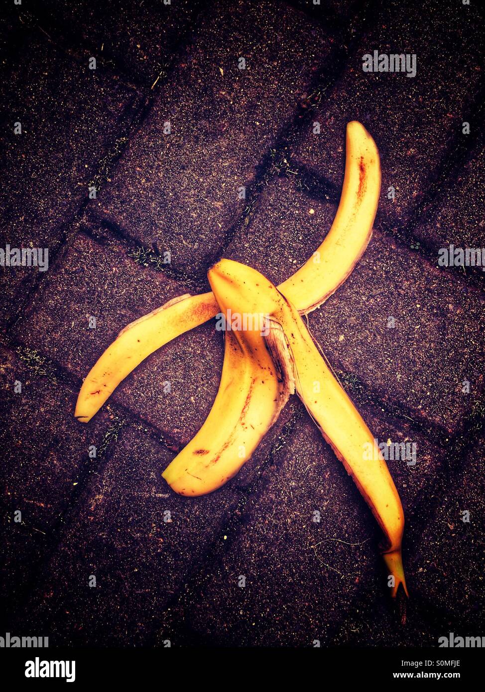 Banana skin on path Stock Photo - Alamy