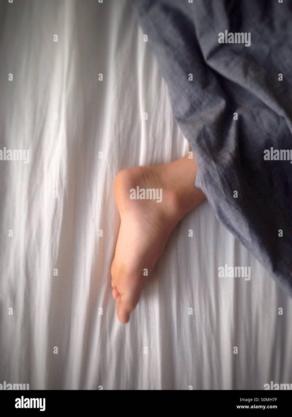 Foot of a sleeping 8 years old child Stock Photo - Alamy