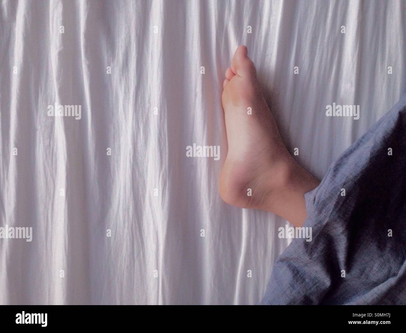 Foot of a sleeping 8 years old child Stock Photo - Alamy