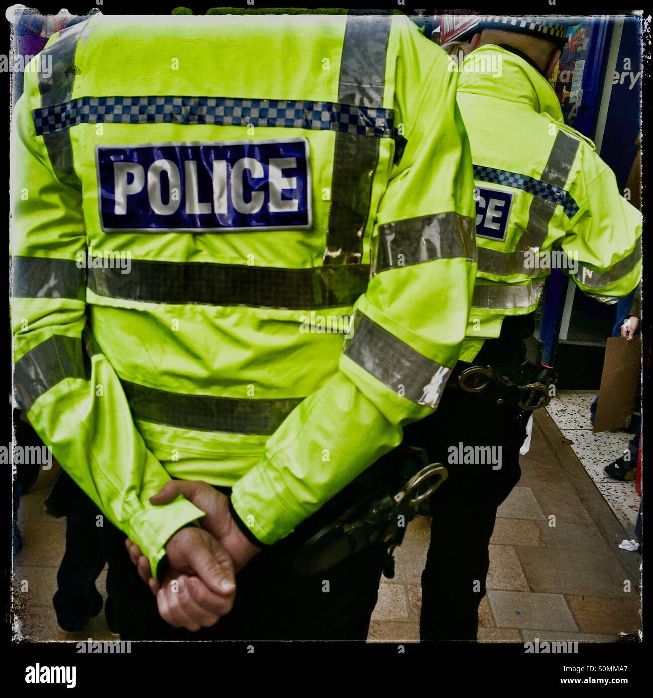 Two policemen rear view Stock Photo - Alamy