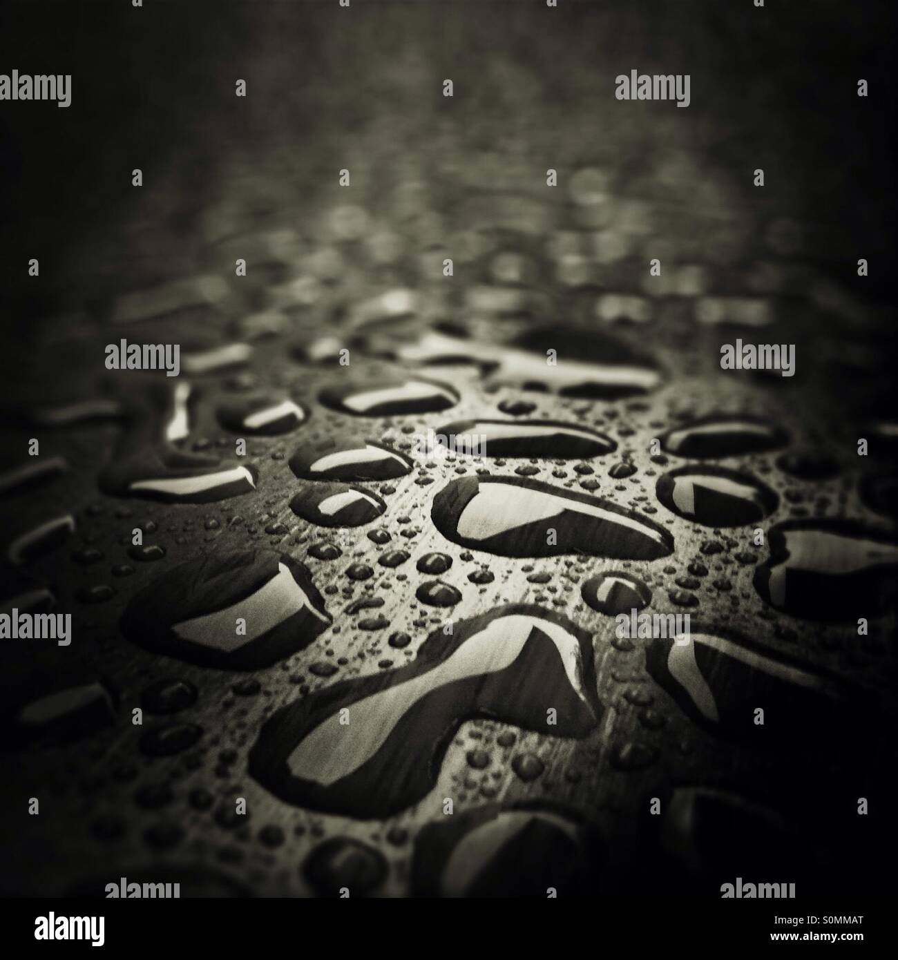 Raining water drops on wood Stock Photo - Alamy