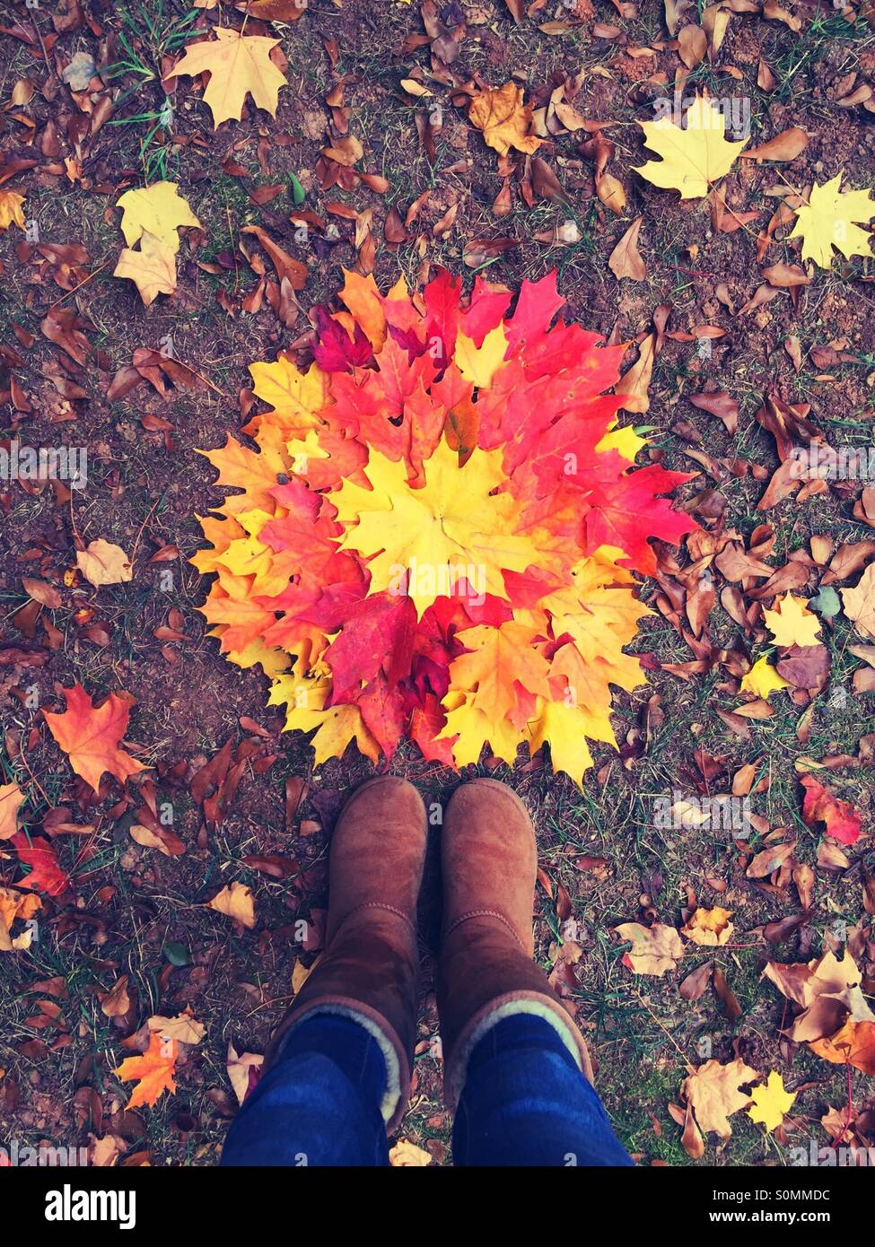 Fall leaves with boots Stock Photo - Alamy
