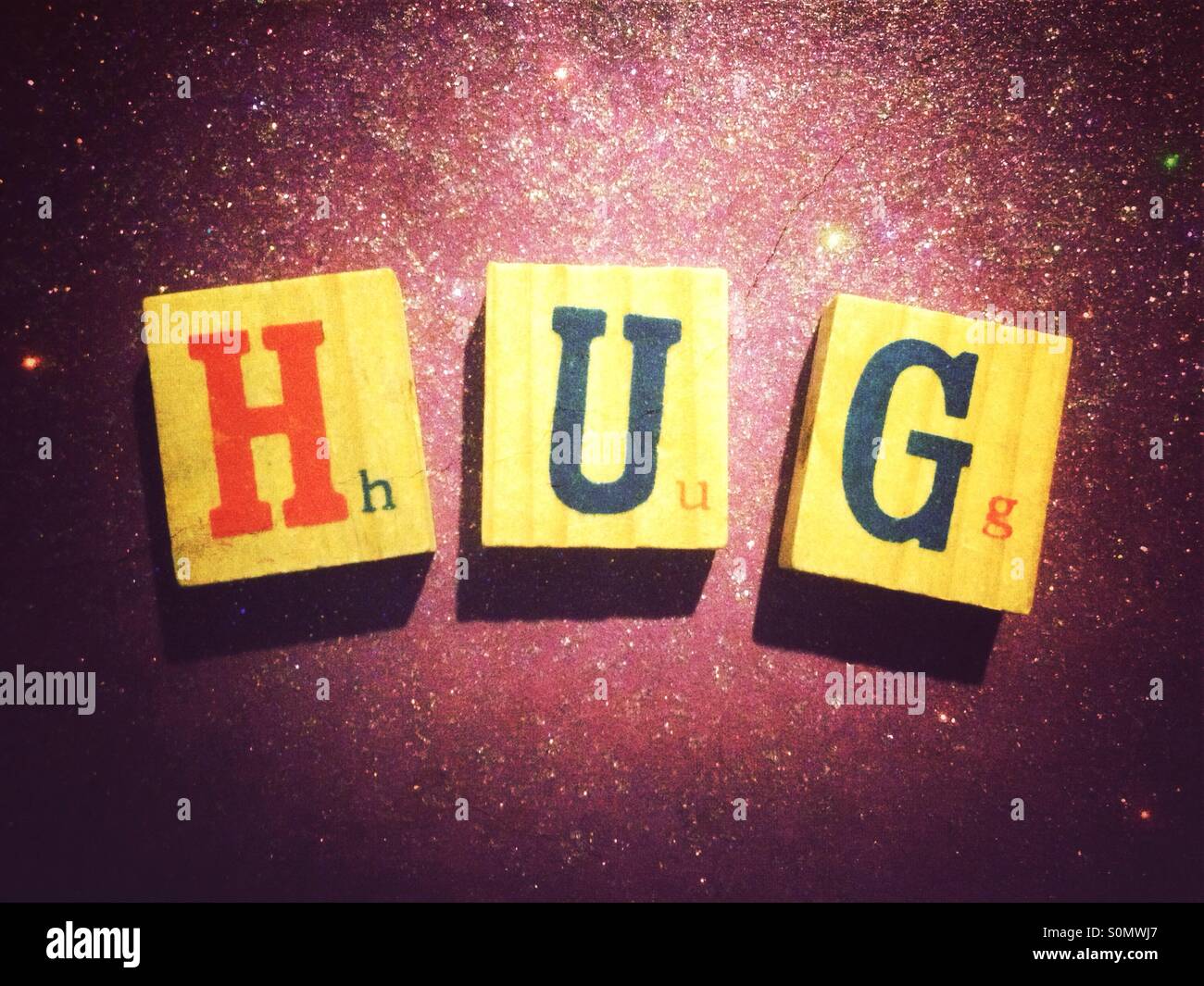 Hug spelled out with a child's wooden letter blocks Stock Photo - Alamy