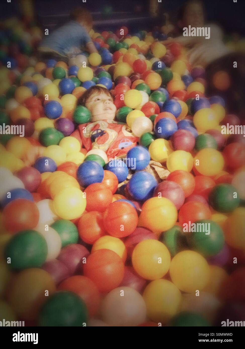 Child playing in ball pit hi-res stock photography and images - Alamy