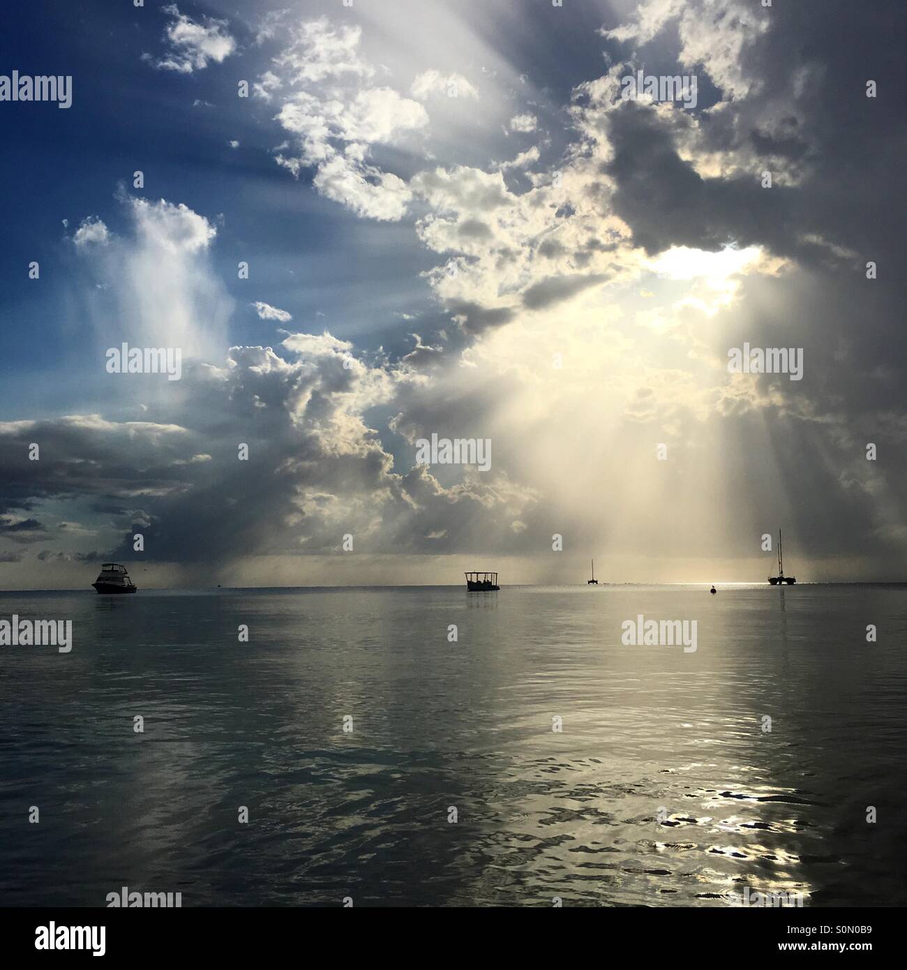 Sun beams shine down on the sea Stock Photo - Alamy
