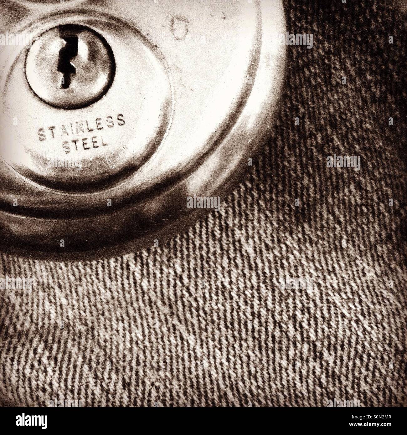 Padlock and keyhole on textured background Stock Photo - Alamy