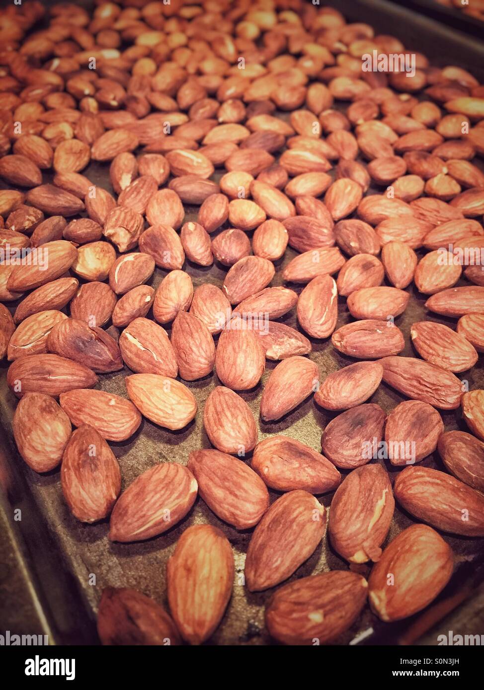 Crunchy oven toasted plain raw almonds Stock Photo - Alamy