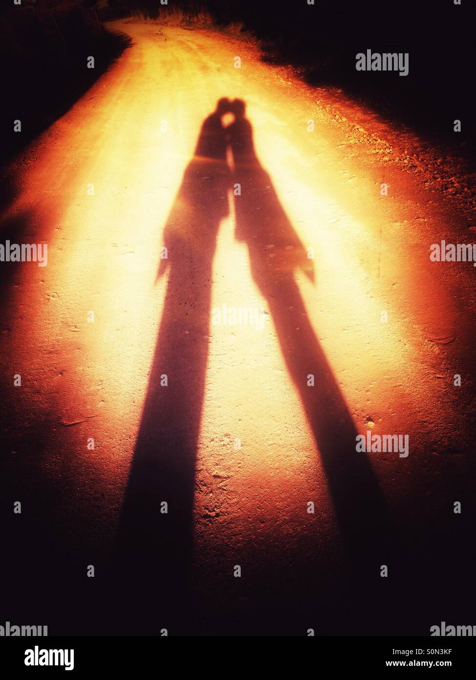 Distorted shadows of two people kissing Stock Photo - Alamy