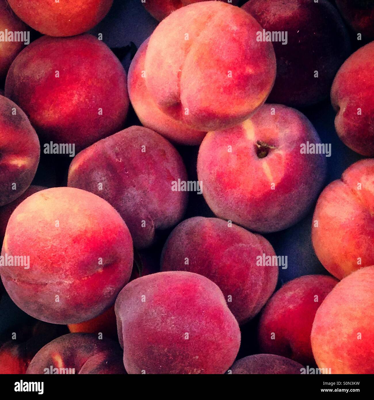 Full frame market stall peaches. Mobile phone photo with some phone or ...