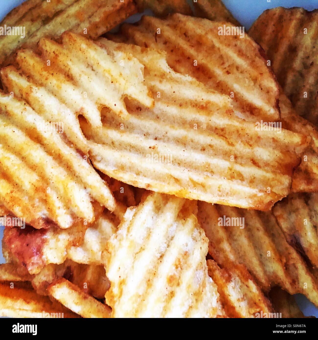 Close-up of ridge cut potato crisps Stock Photo - Alamy