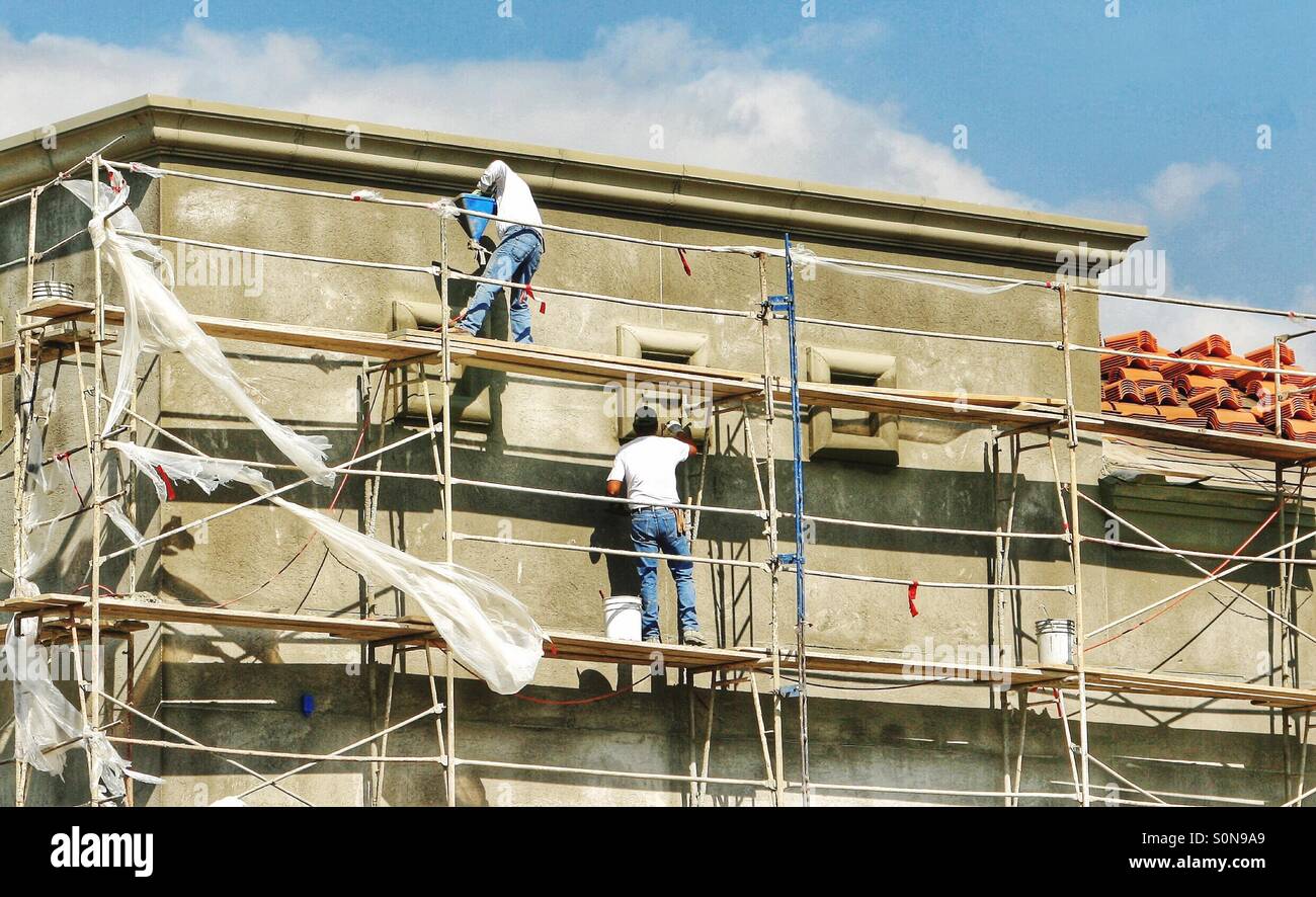 Construction Workers At Work On A New Building Stock Photo - Alamy