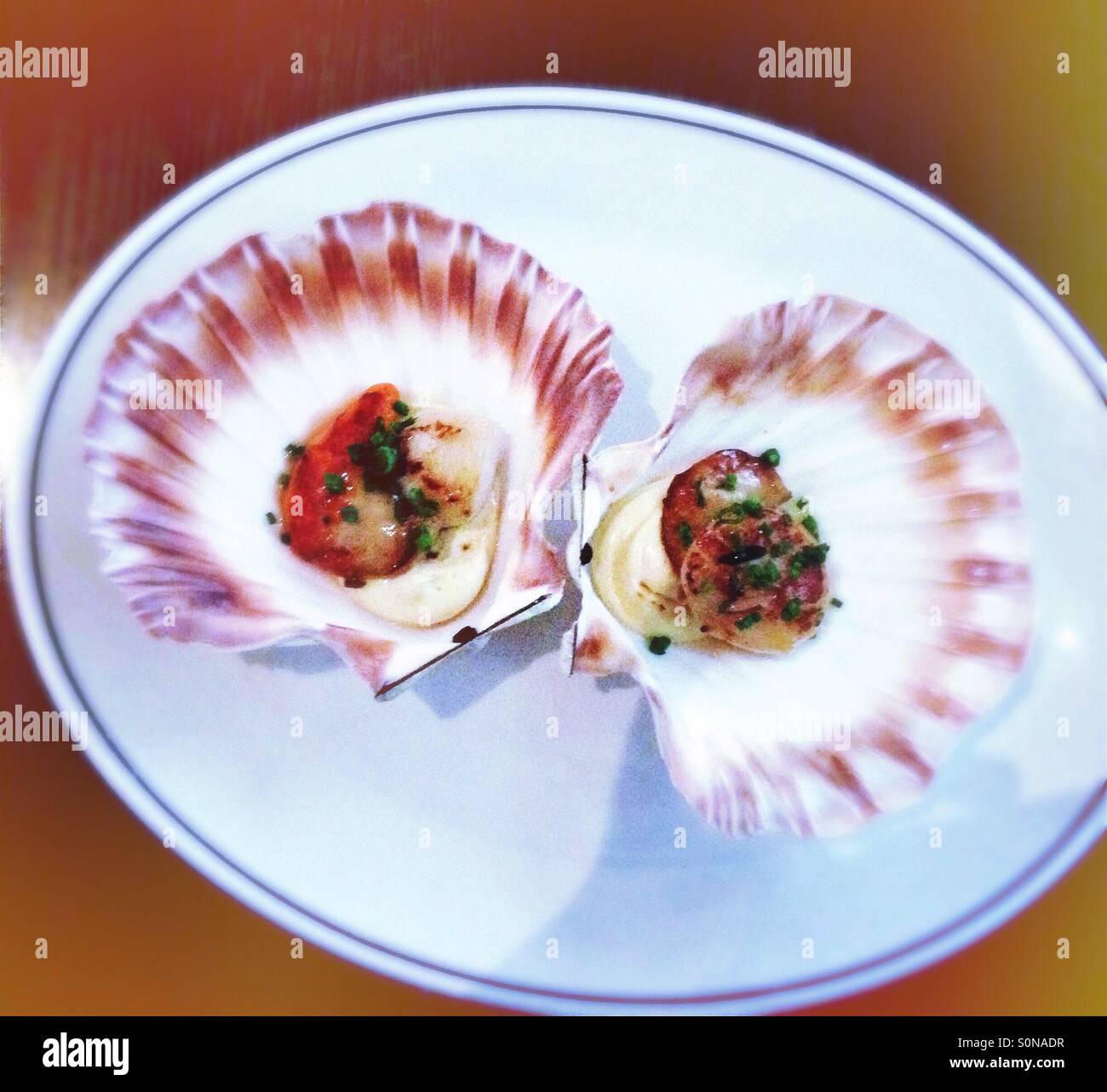 Scallops in a restaurant Stock Photo - Alamy