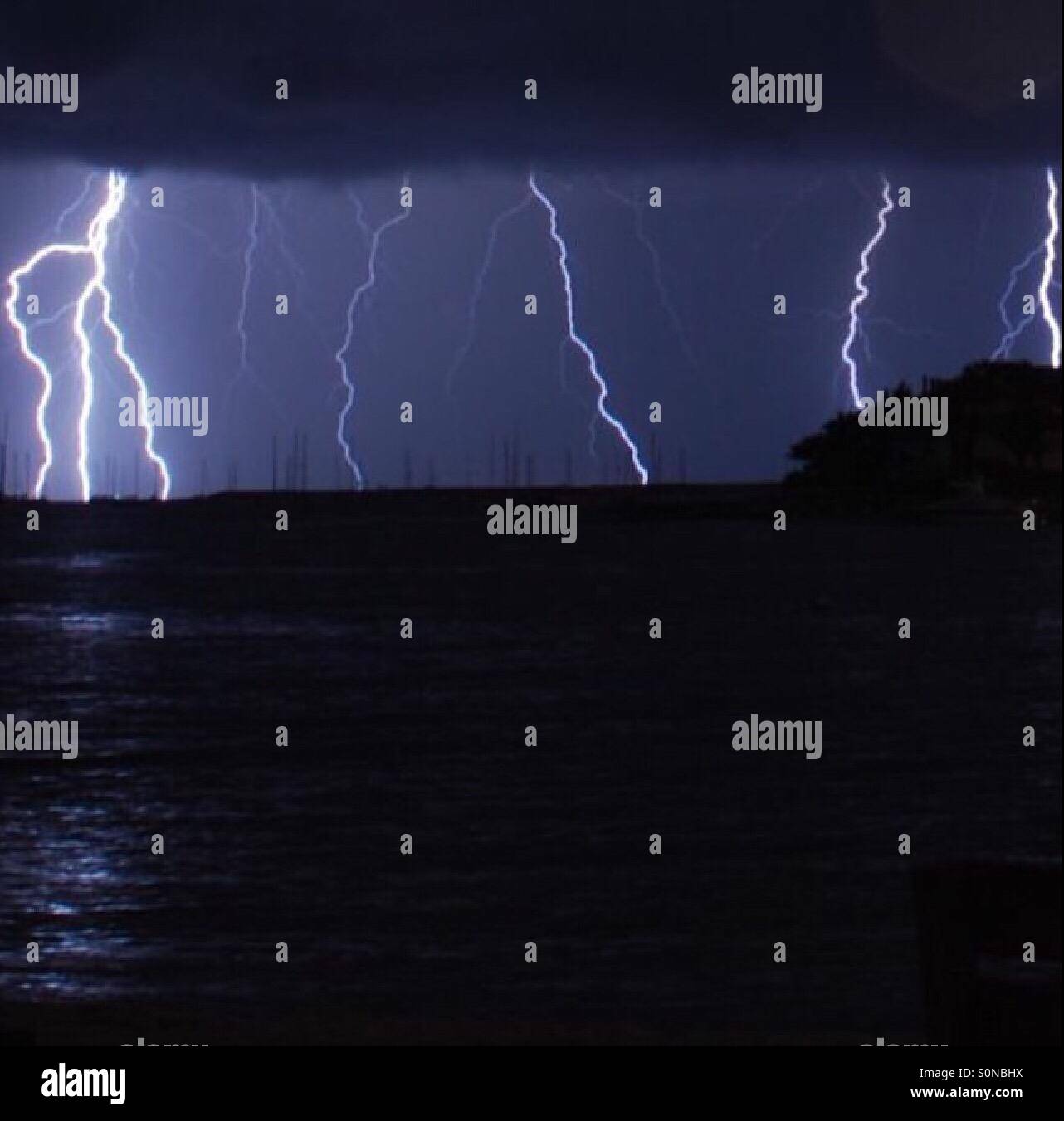 Lightning over ocean Stock Photo - Alamy