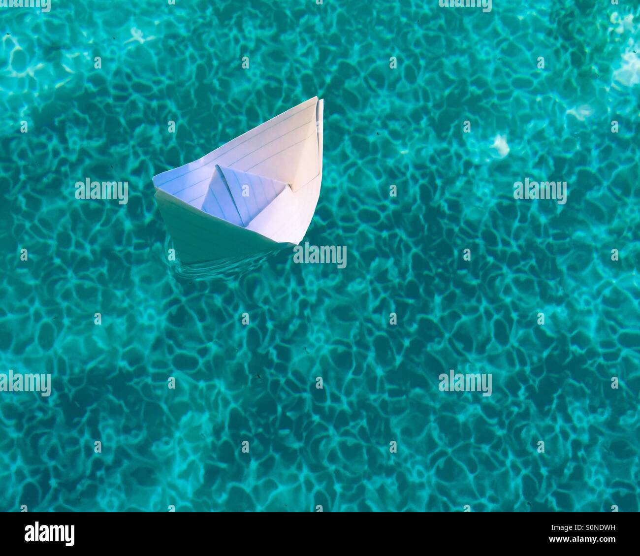 Paper boat floating in the swimming pool Stock Photo - Alamy