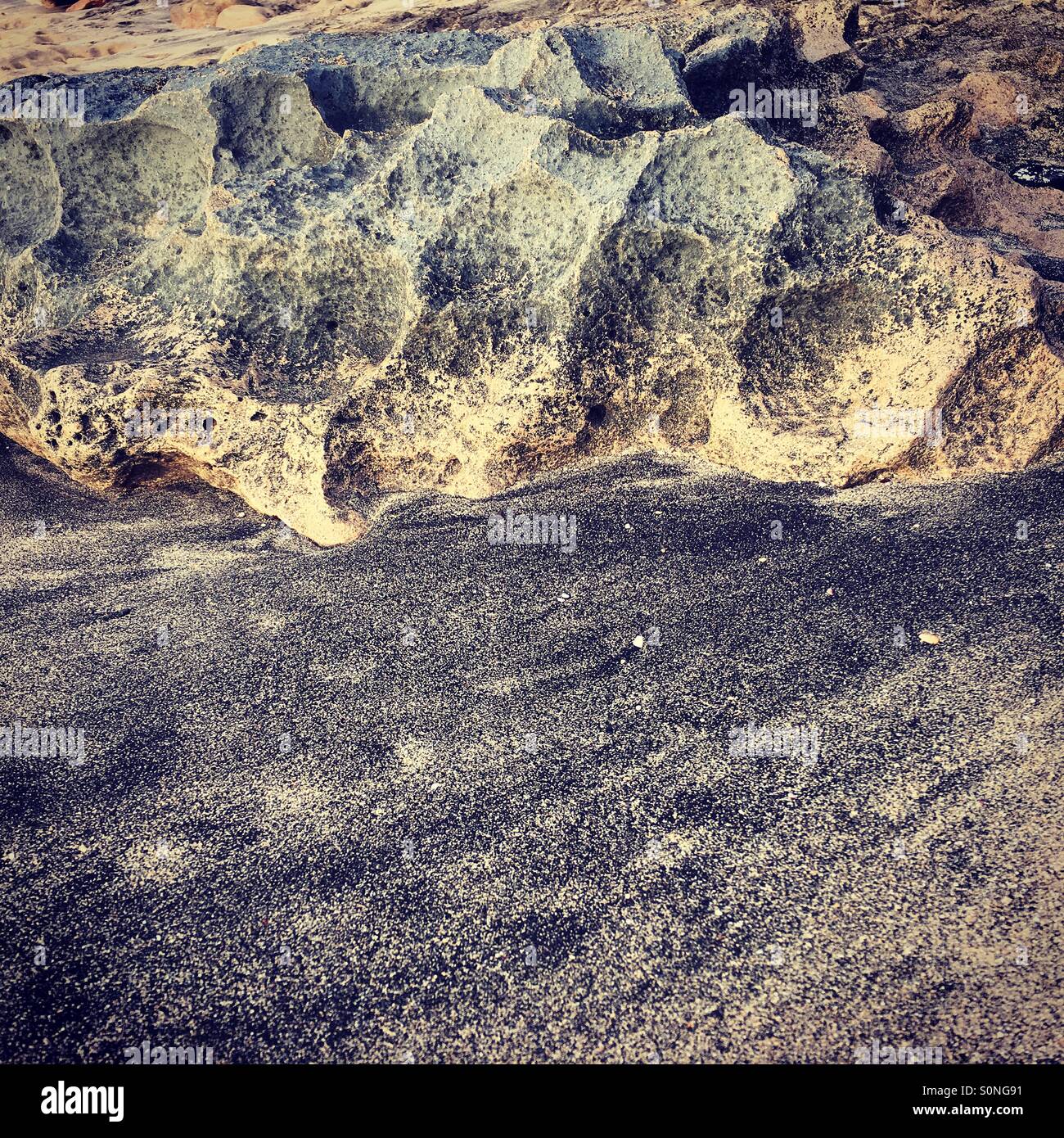 Volcanic sand against volcanic rock Cape Verde Stock Photo - Alamy
