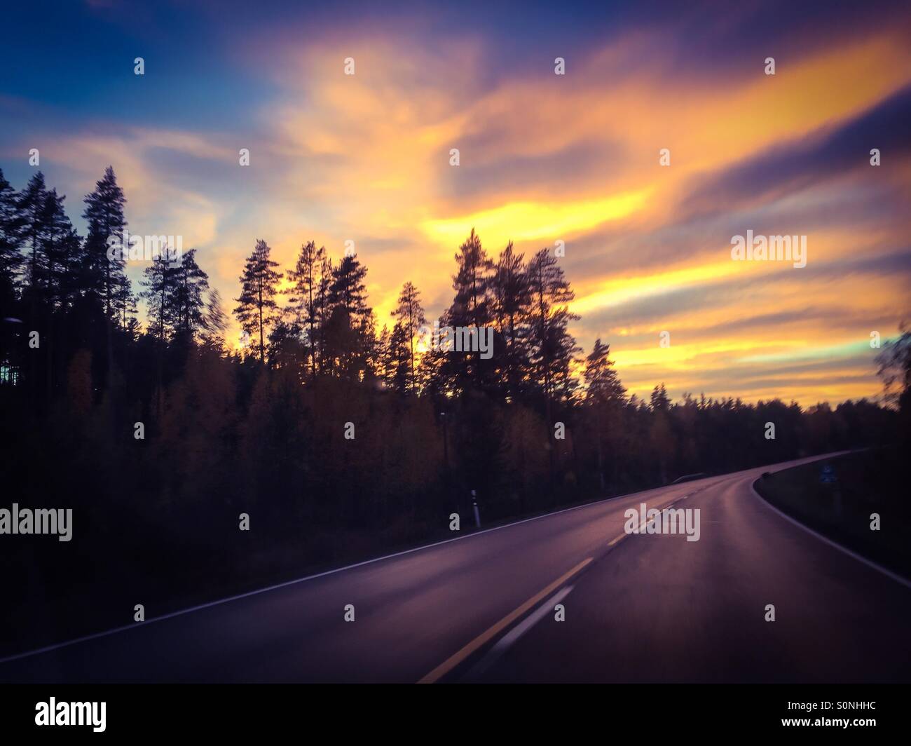 A sunset on the road Stock Photo - Alamy