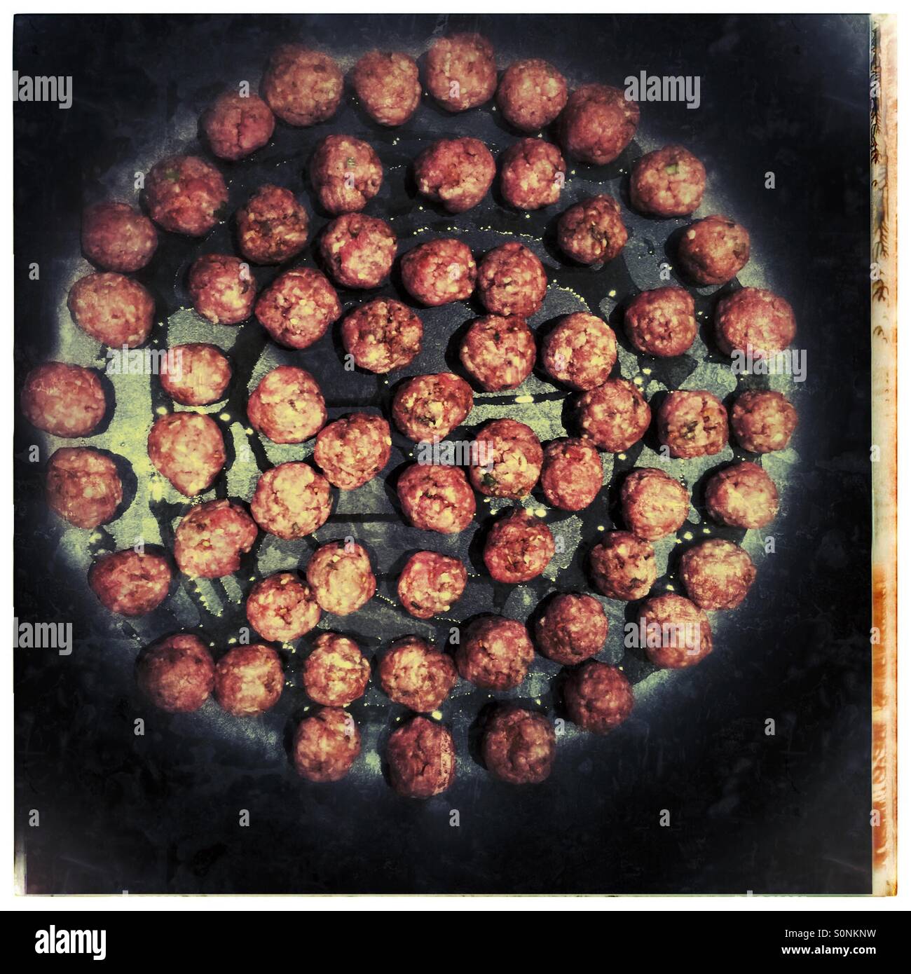 Uncooked meatballs in pan Stock Photo - Alamy