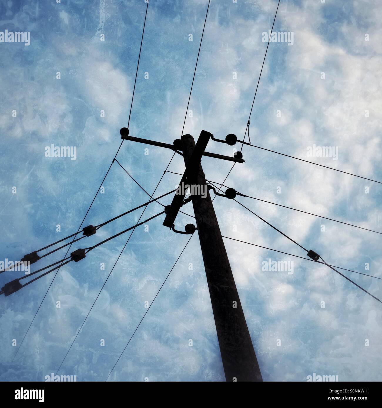 Looking up at pole, power lines and cables on an Autumn morning (grunge ...