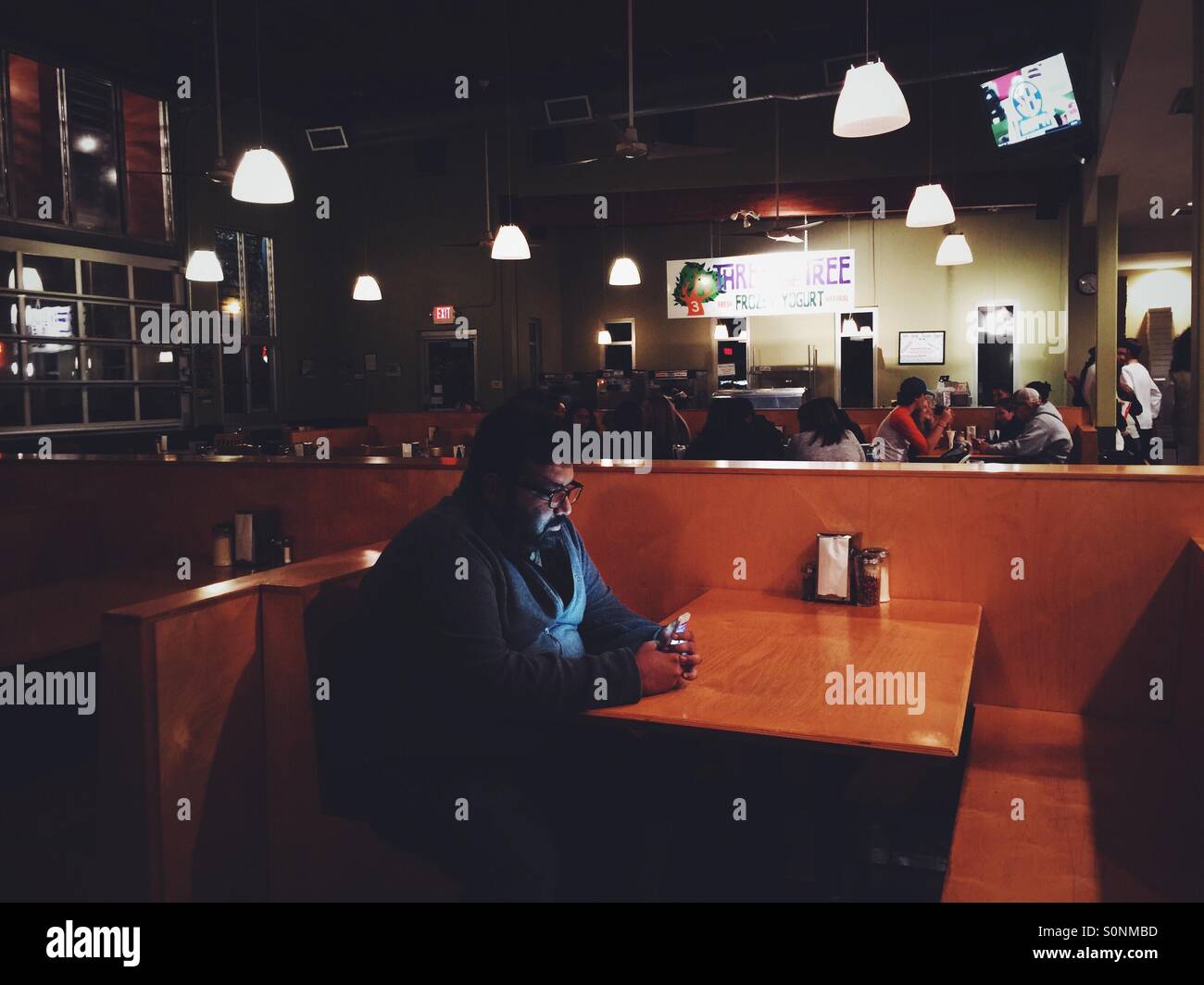 Texting in restaurant Stock Photo - Alamy