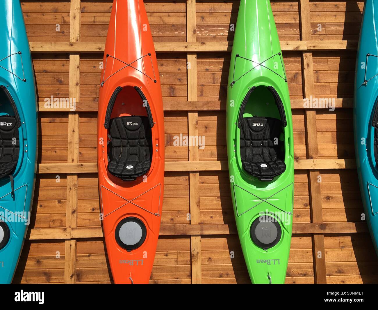 Brightly colored kayaks on display for sale Stock Photo - Alamy