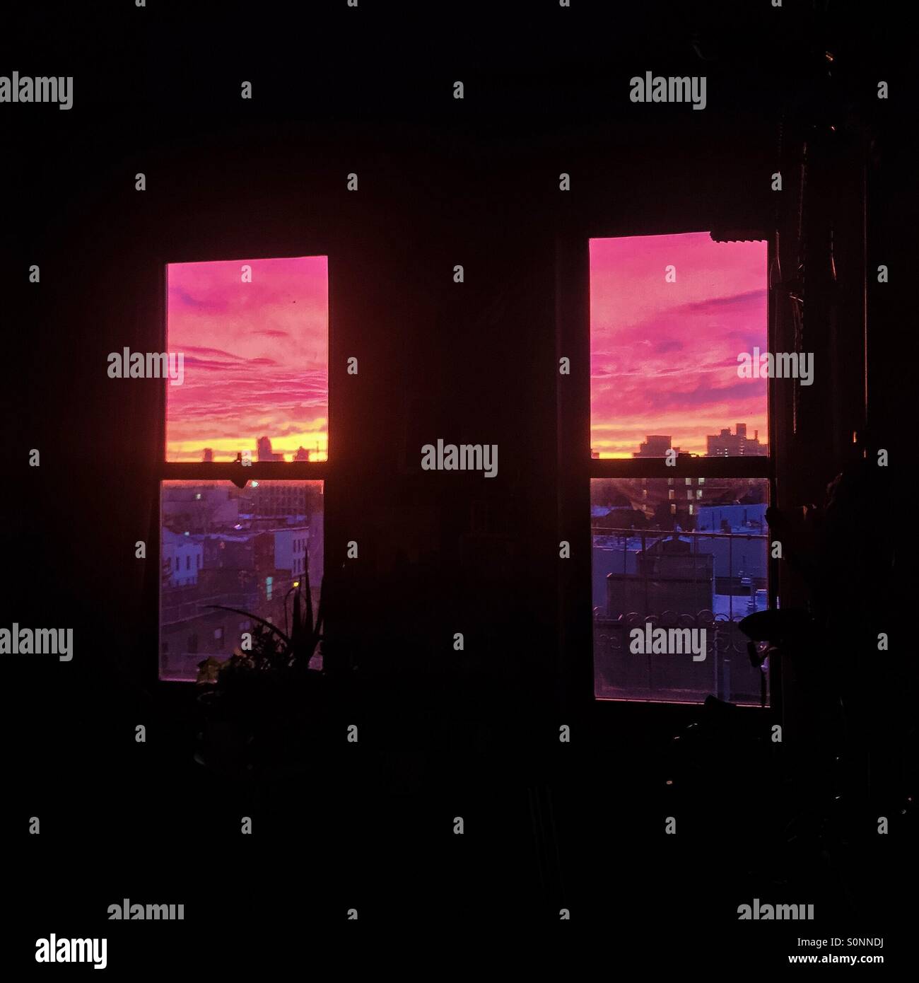 Beautiful sunset of New York City from two window in an apartment in ...