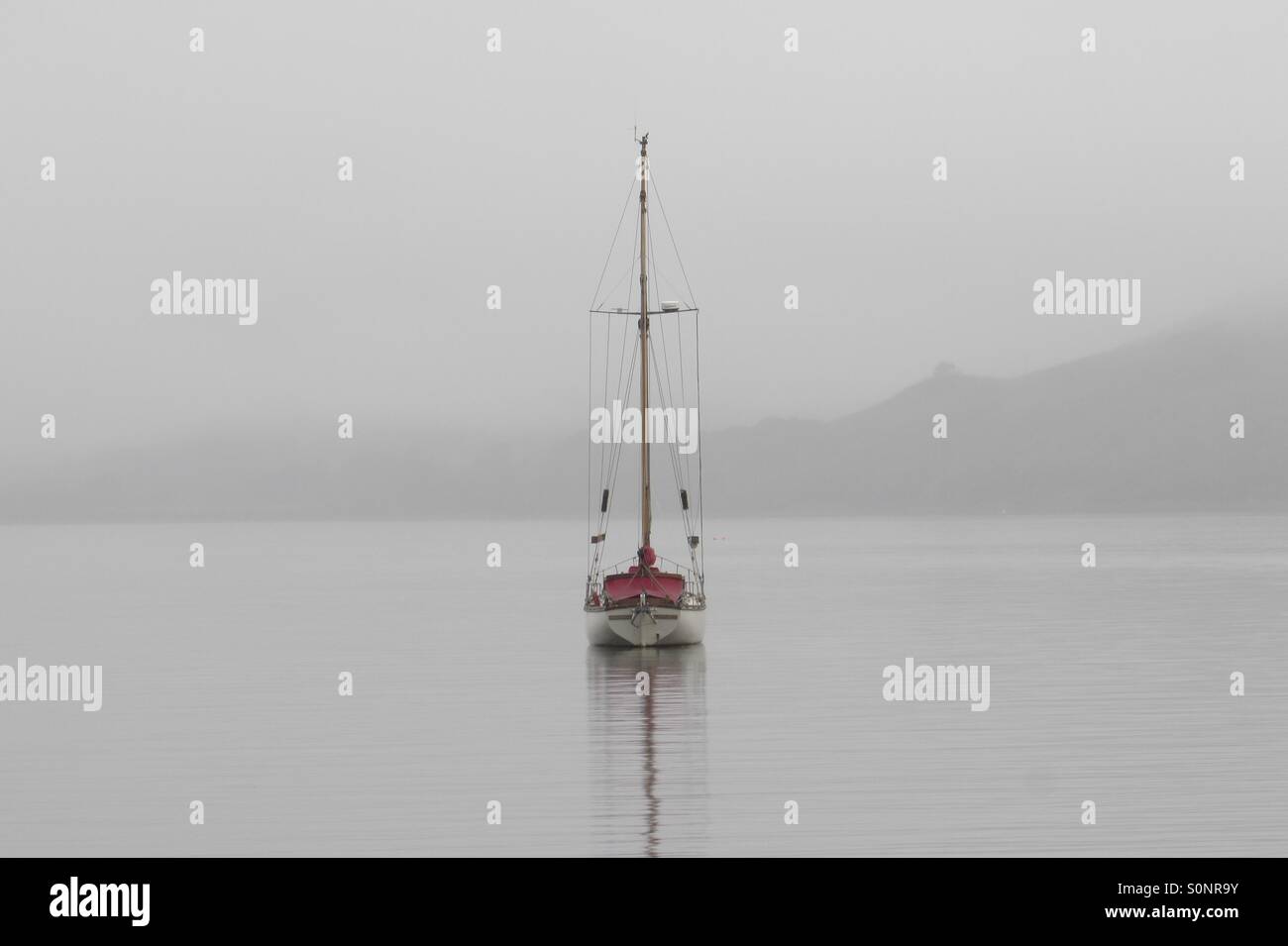 Boat in the mist Stock Photo - Alamy