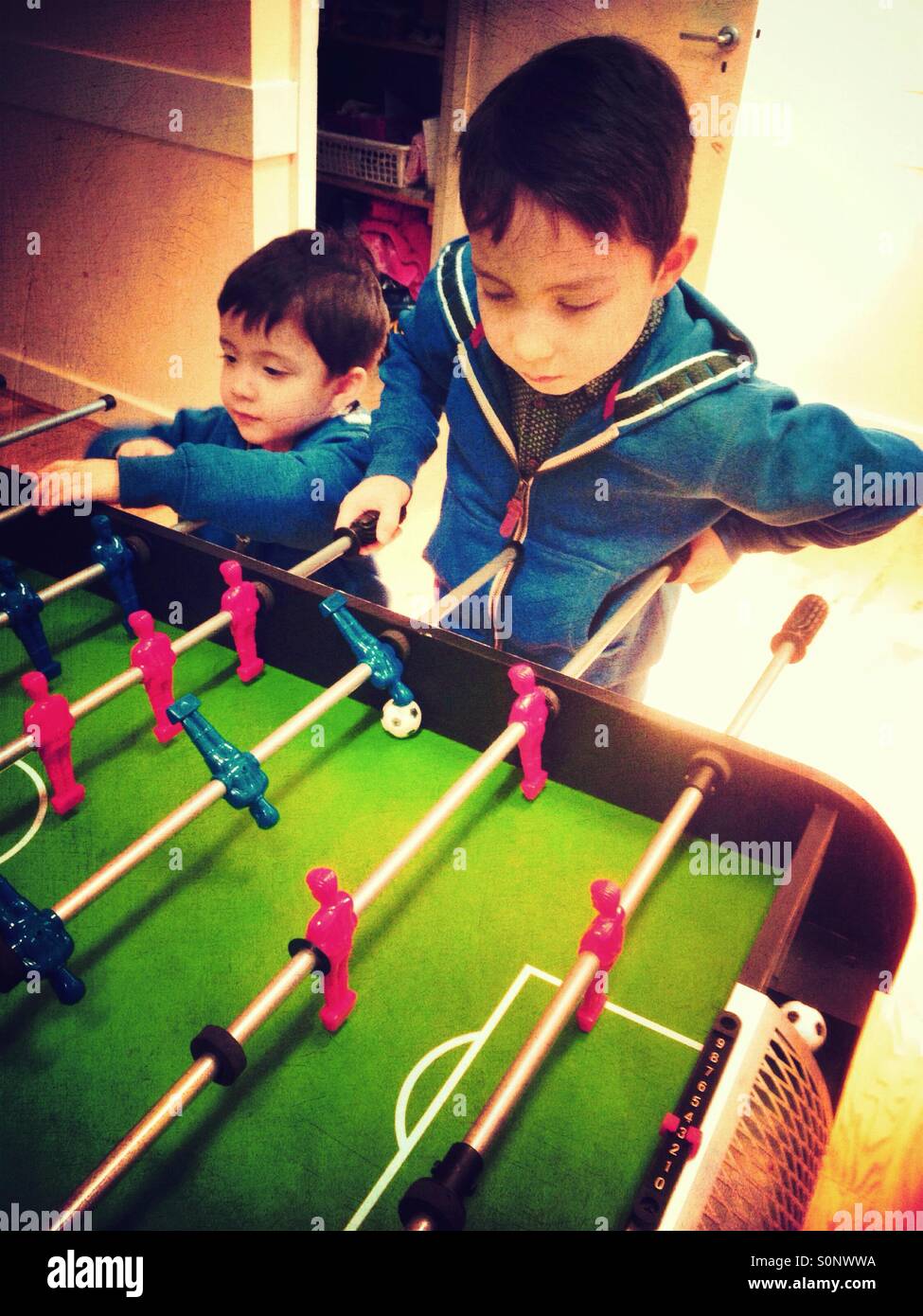 Young boys playing table football Stock Photo - Alamy