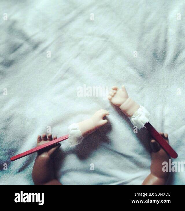 Doll hands holding doll hands Stock Photo - Alamy