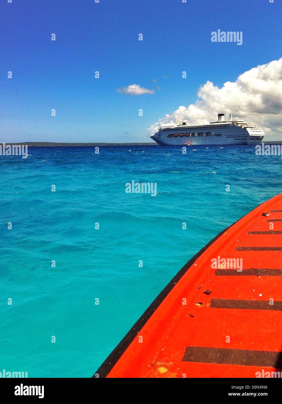Cruise ship on Pacific Ocean viewed from a red tender boat Stock Photo ...