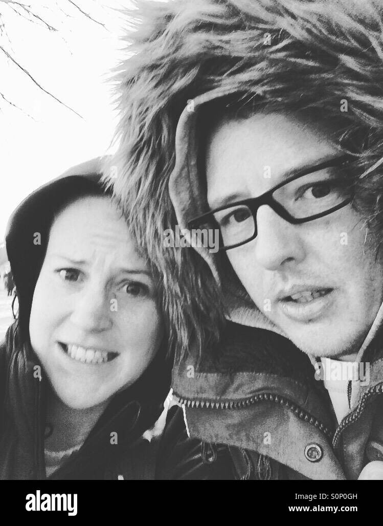 Two cold people wrapped up for winter Stock Photo - Alamy