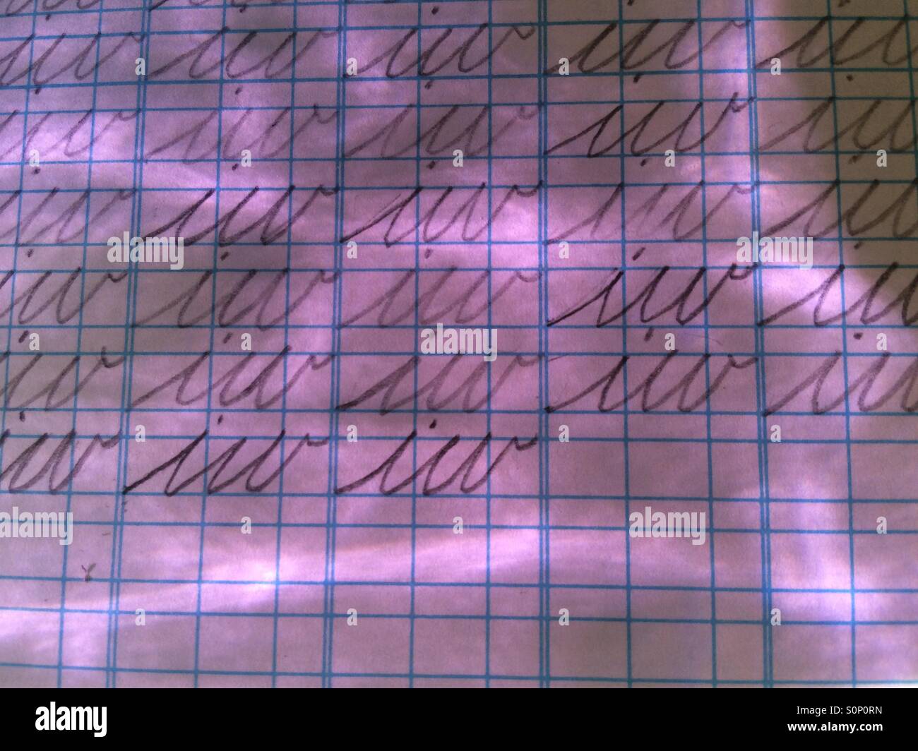 Spencerian script on purple sunlit page Stock Photo - Alamy