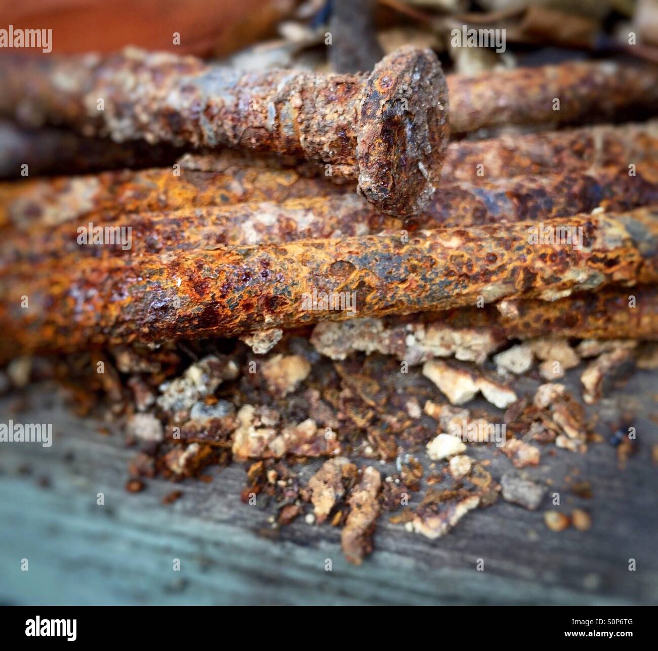 Rusty and friable steel spikes flaking off pieces of rusted metal onto ...