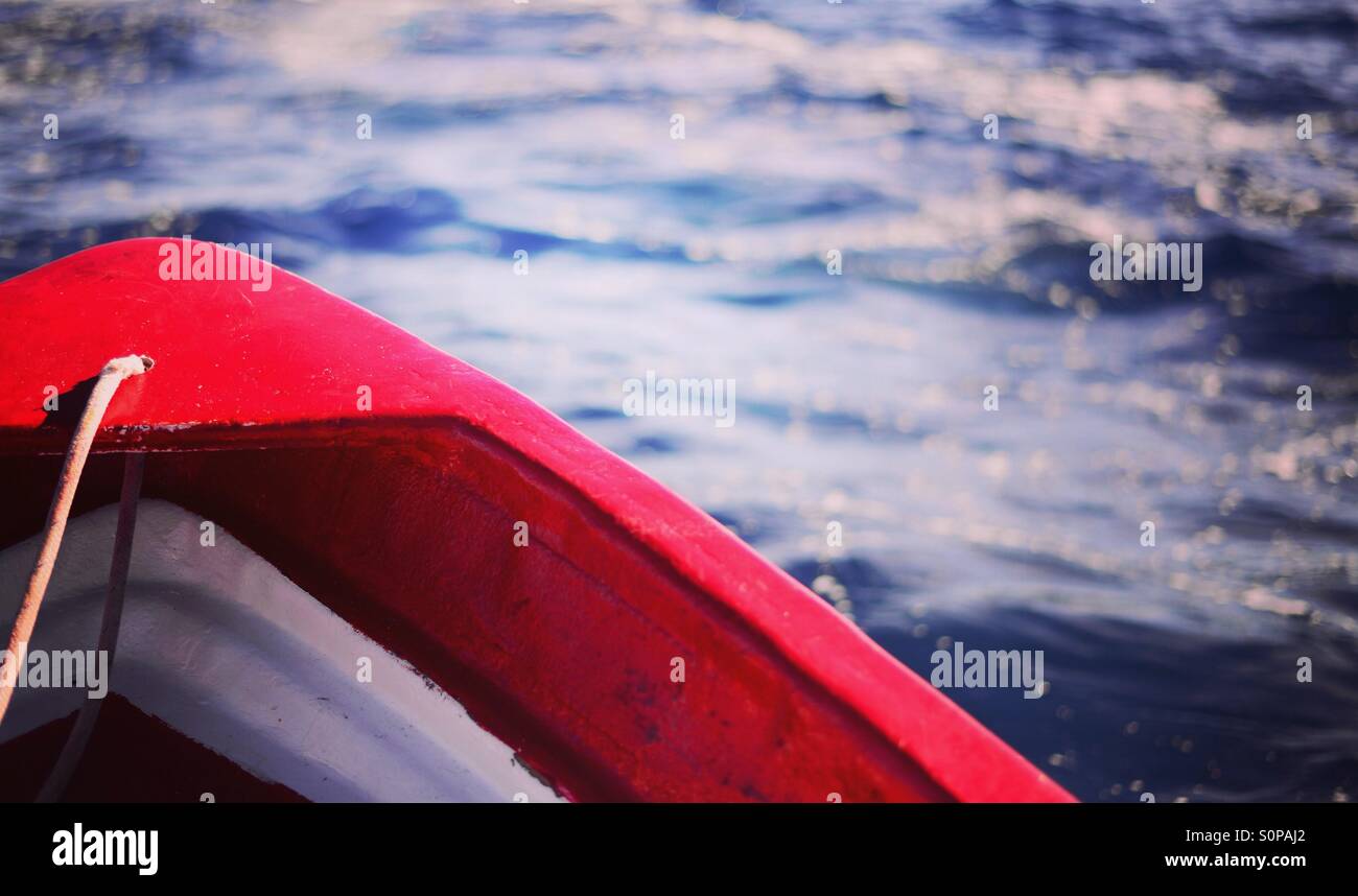 Red boat on the ocean Stock Photo - Alamy