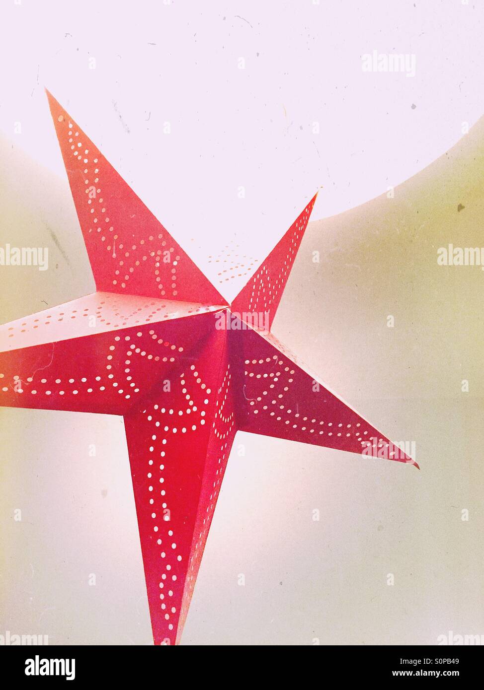 Red star. Christmas decoration hanging from a lamp Stock Photo - Alamy