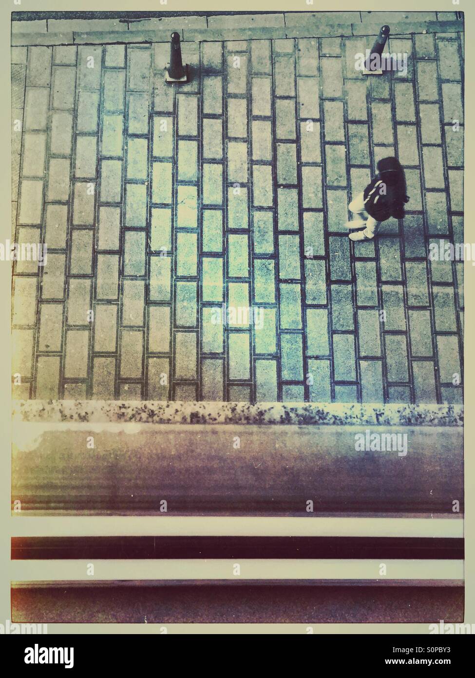 Lone woman walking seen from above through a window Stock Photo - Alamy