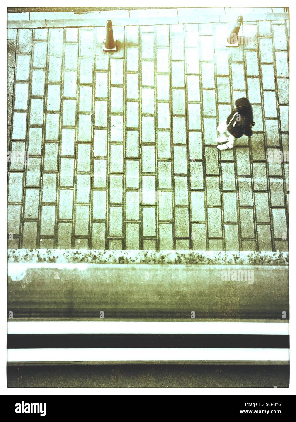 Lone woman walking seen from above through a window Stock Photo - Alamy