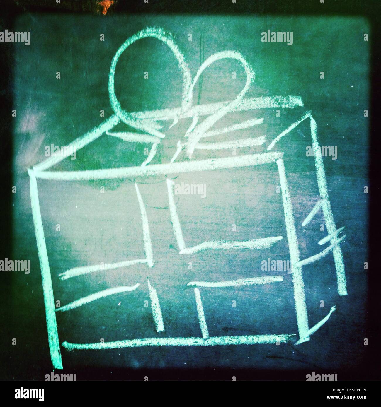 Wrapped gift on a blackboard drawn with chalk Stock Photo - Alamy
