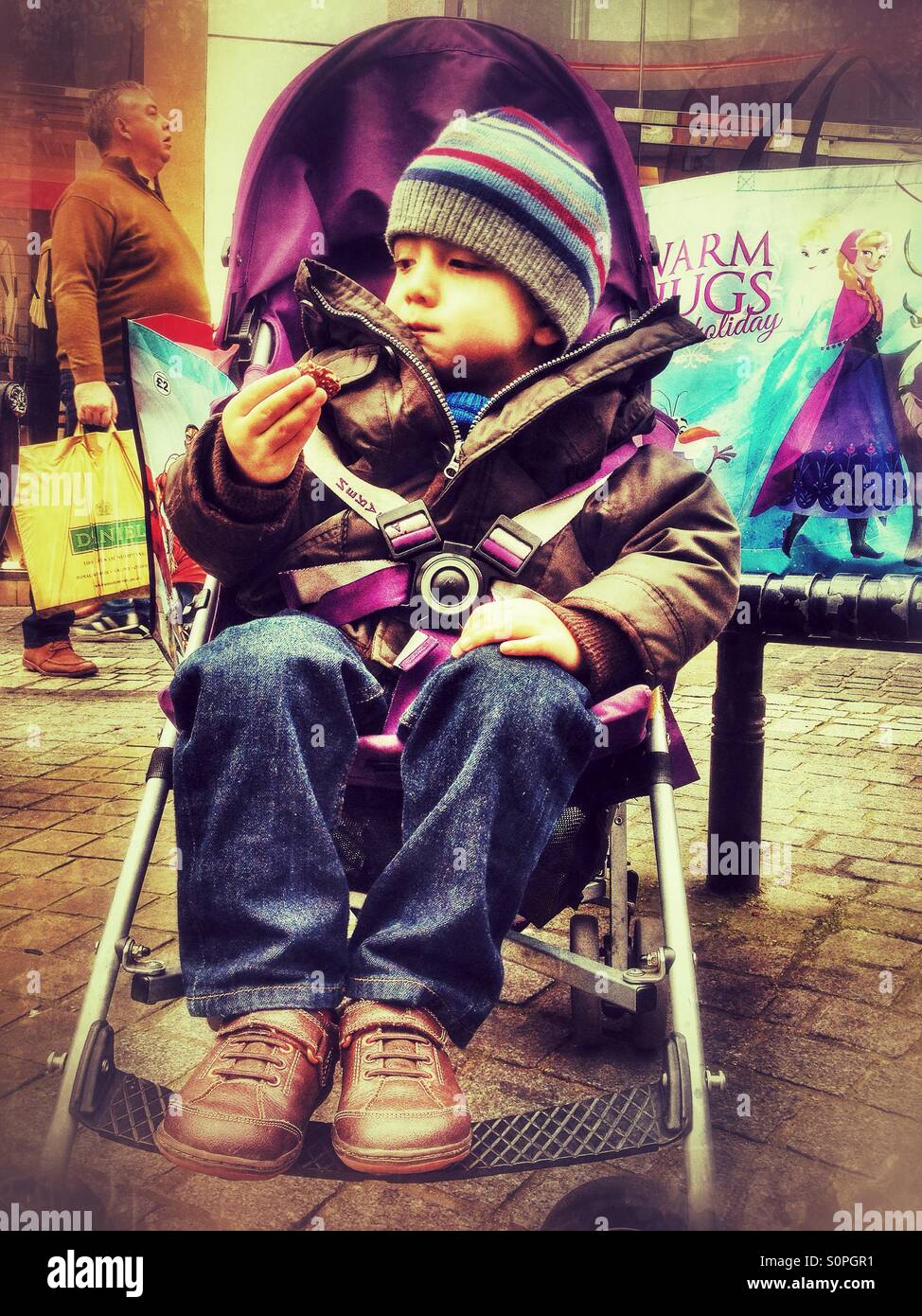 A young boy in a pushchair Stock Photo - Alamy