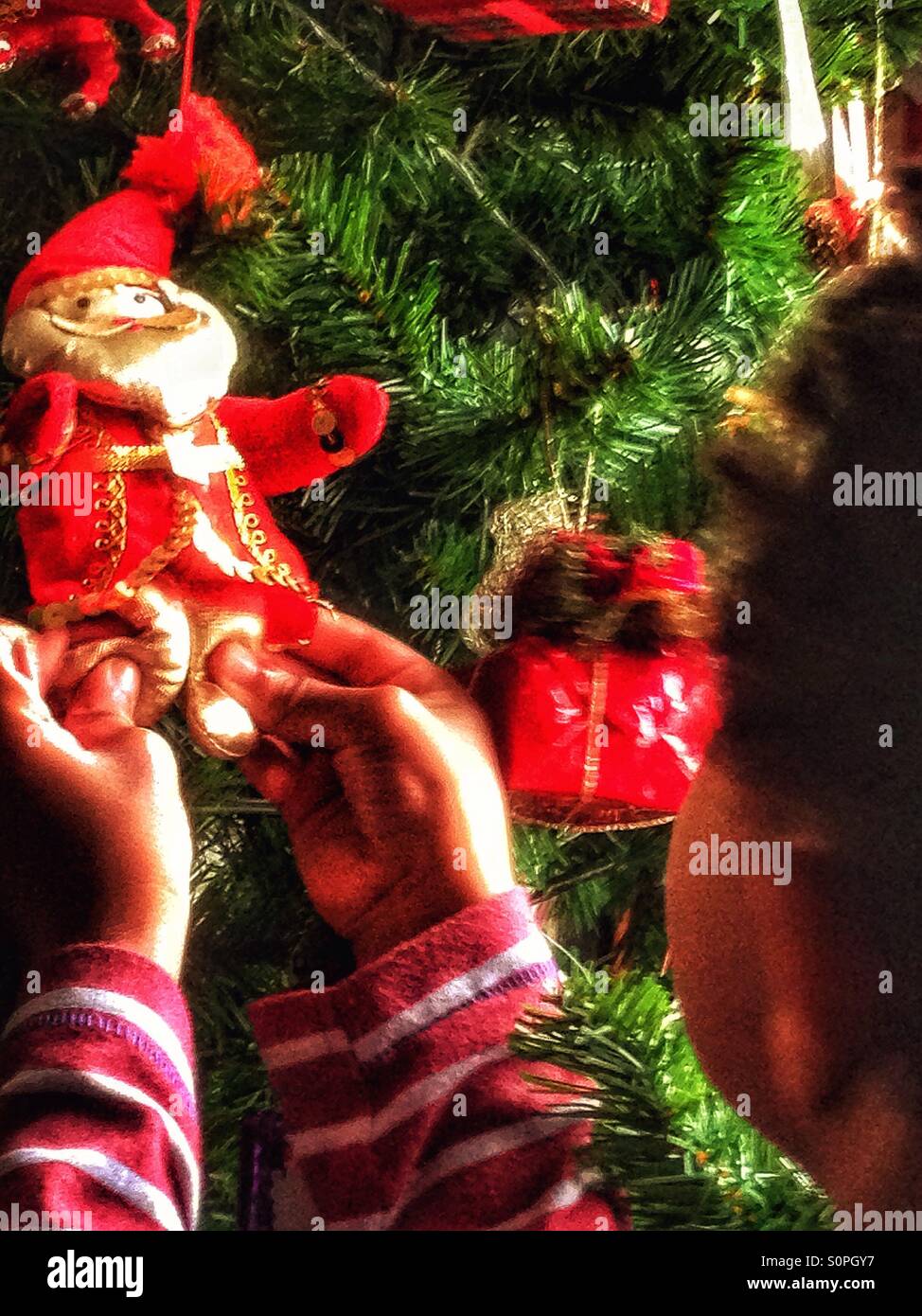 A child plays with Christmas tree decorations Stock Photo - Alamy