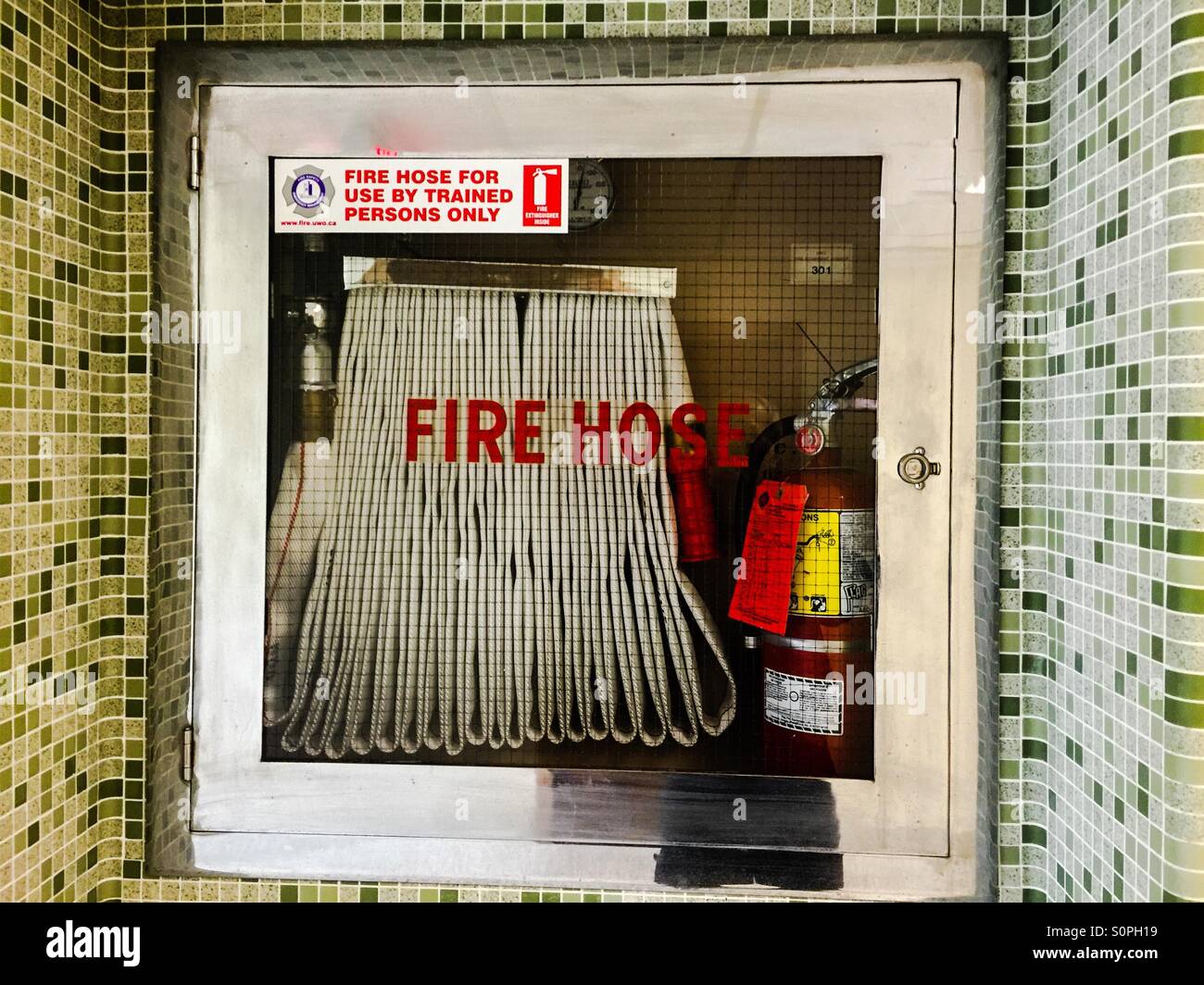Fire hose tiled enclosure Stock Photo - Alamy