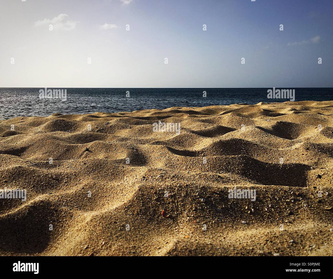 Ripples in the sand with the ocean in he background Stock Photo - Alamy
