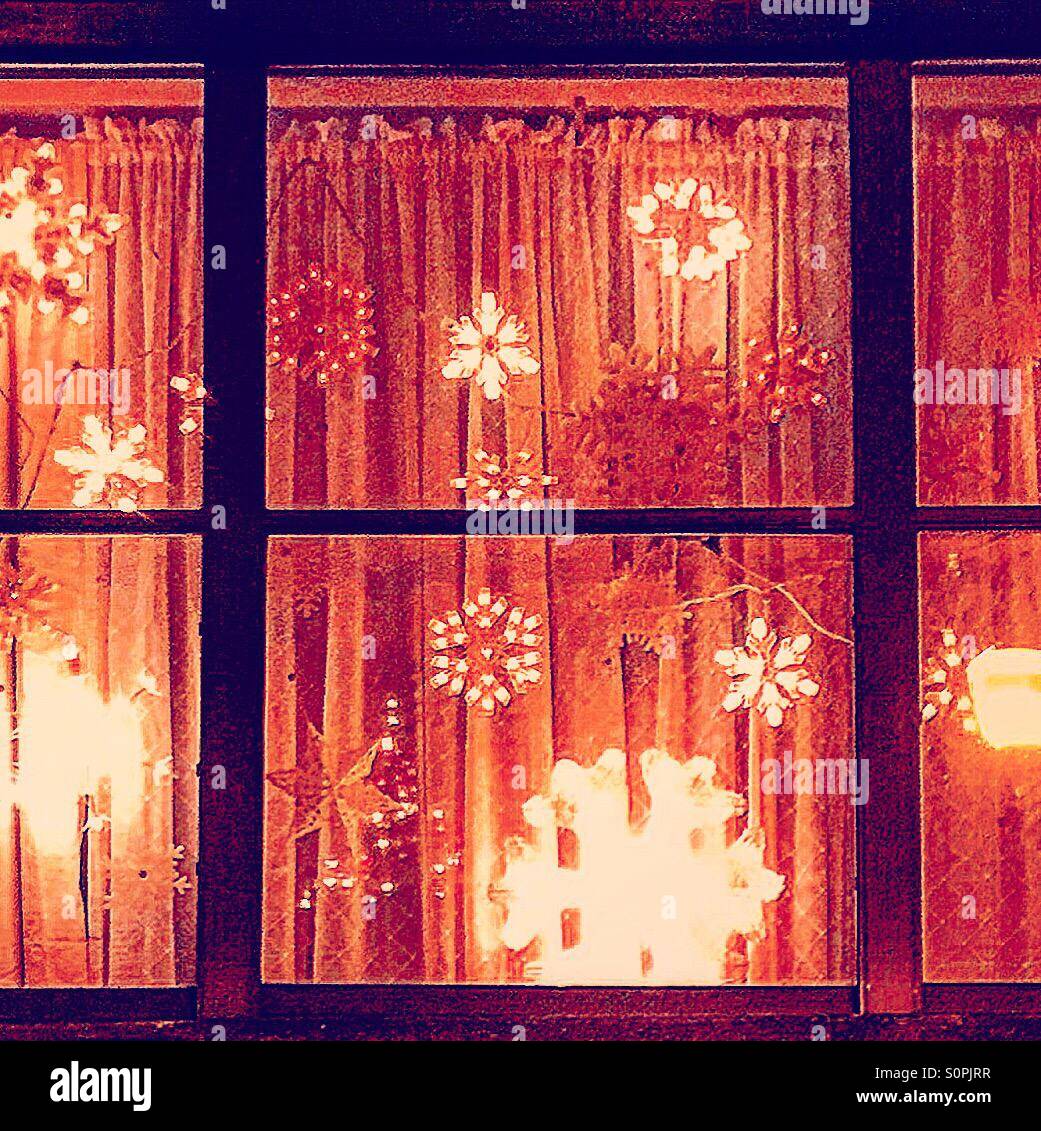 Snowflakes light up a window Stock Photo - Alamy