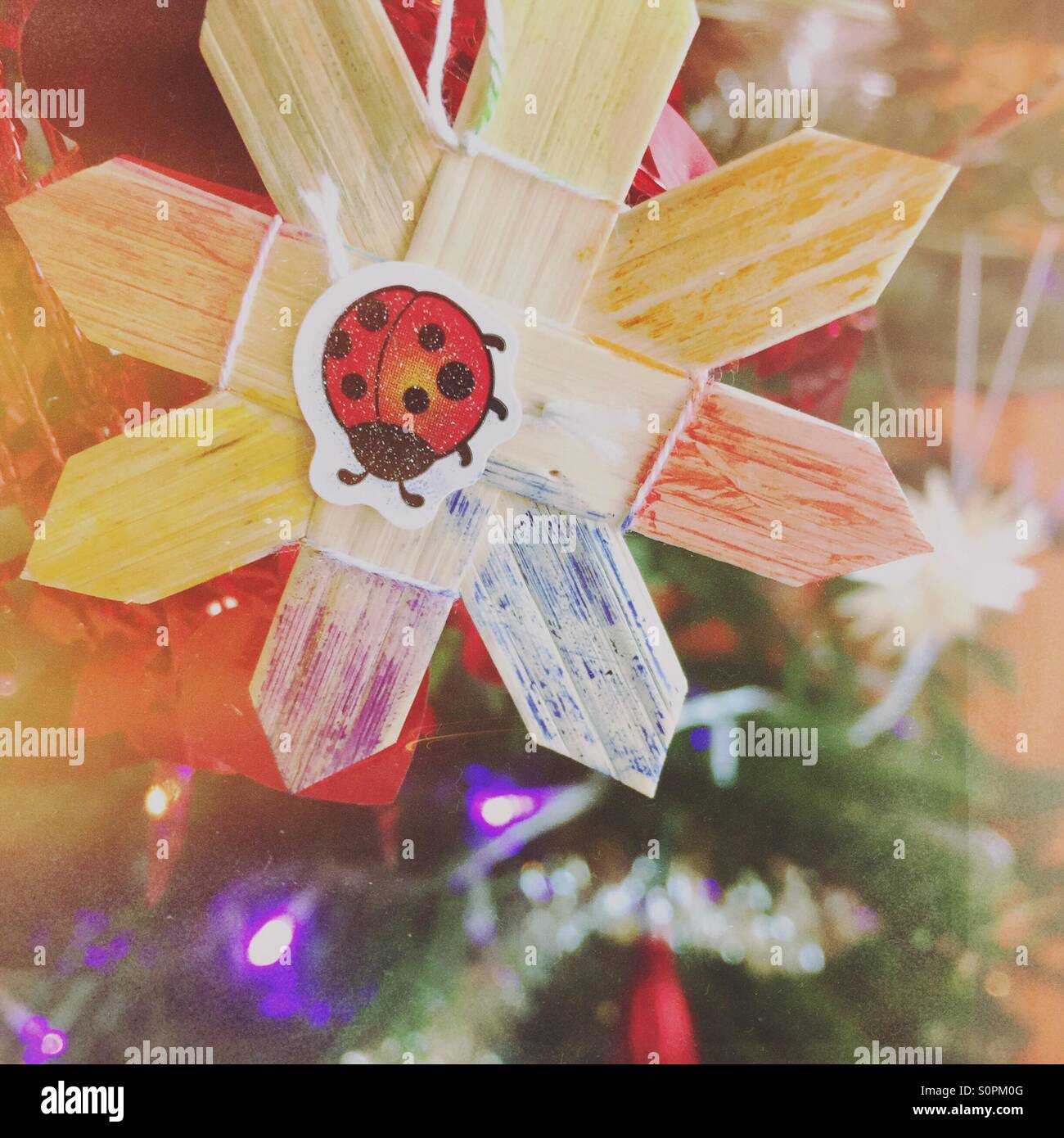 Little girls self made Christmas decoration with ladybird sticker Stock ...