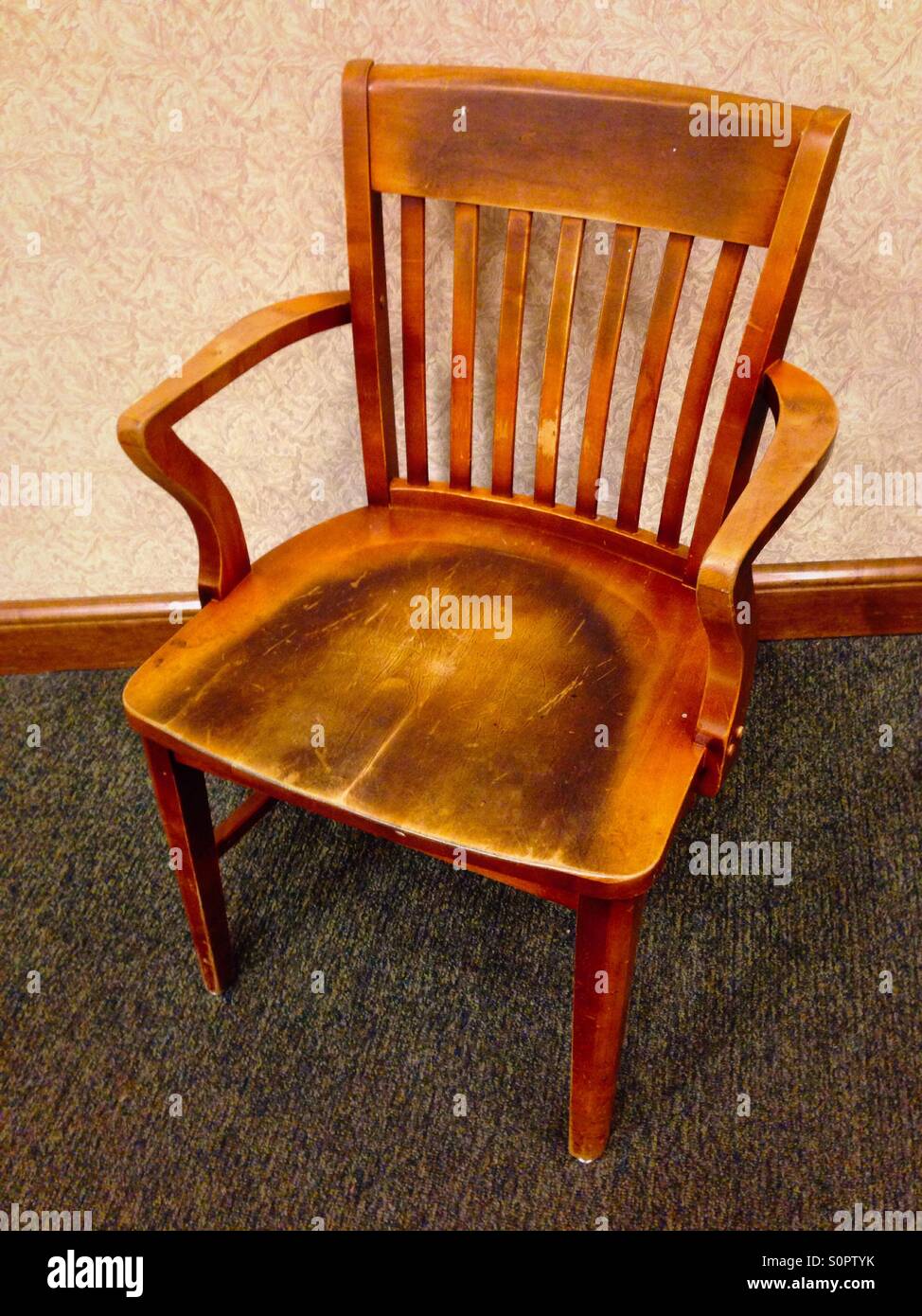 Old, worn wooden chair against a blank wall Stock Photo - Alamy