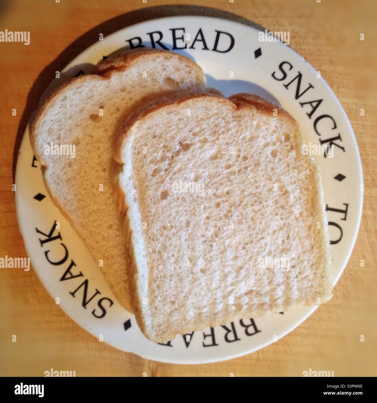 Two slices of white bread on a plate Stock Photo - Alamy