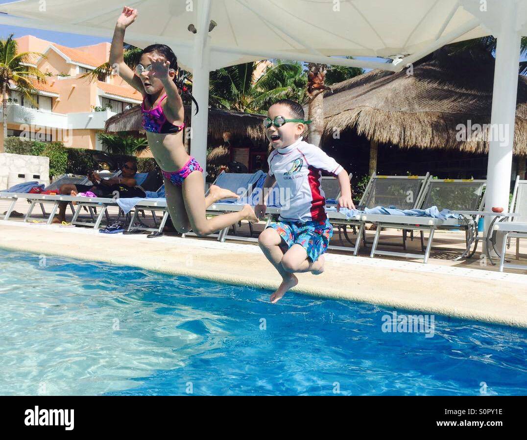 kIds jumping into pool Stock Photo - Alamy
