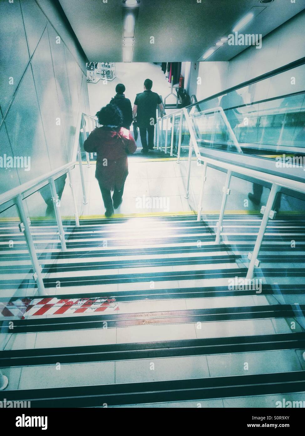 Going downstairs at a high street store Stock Photo - Alamy