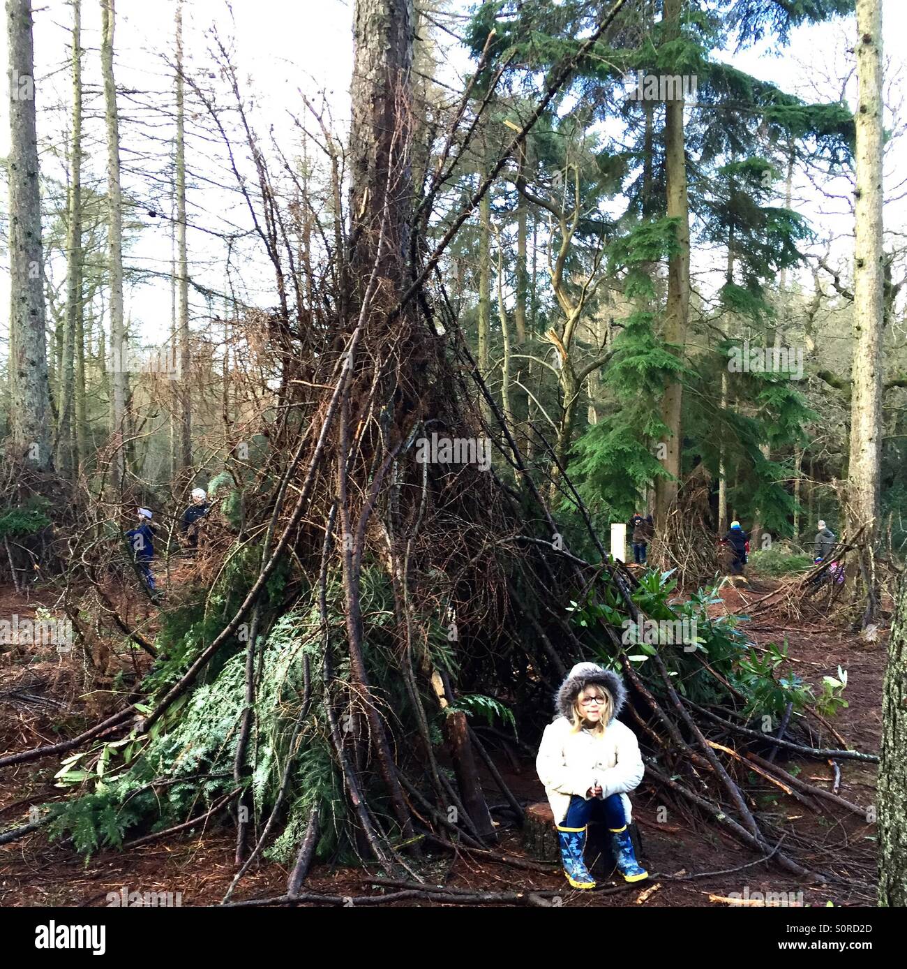 Den in the woods with girl at entrance Stock Photo - Alamy