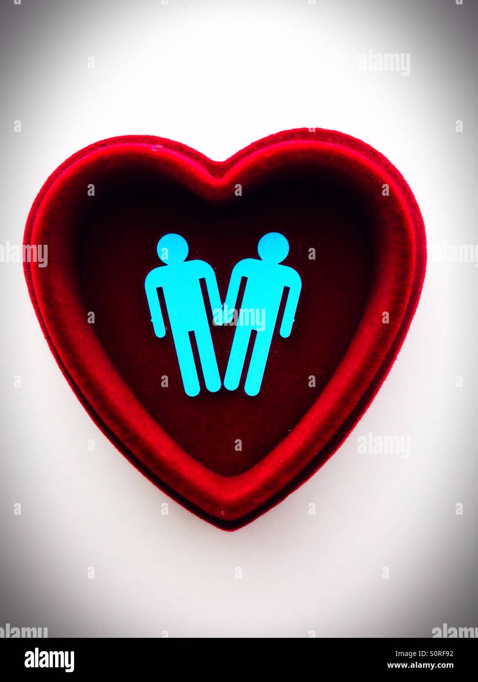 Symbol of two men inside a heart shaped box Stock Photo - Alamy