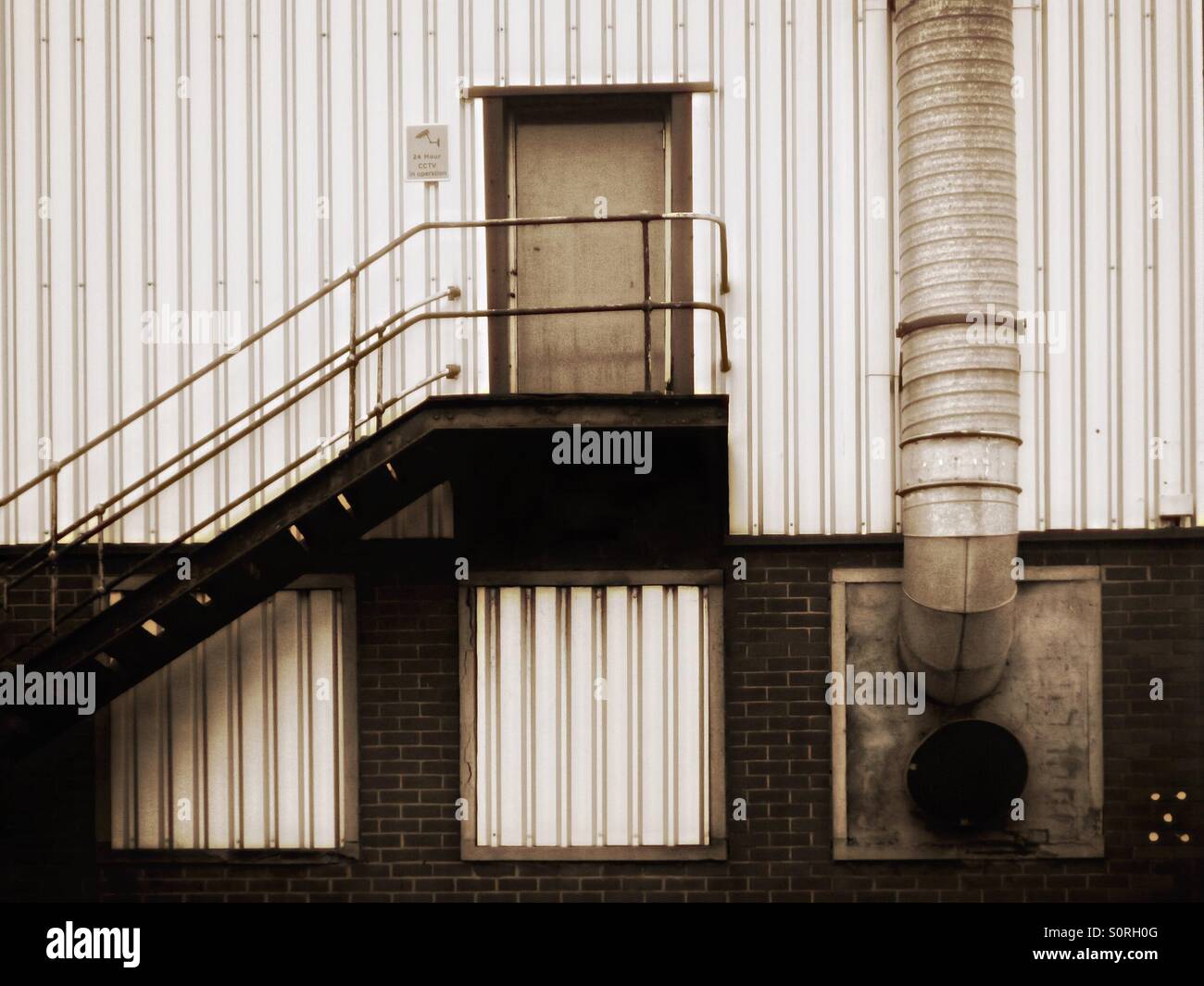 Old style factory with aluminium sheeting and flue Stock Photo - Alamy